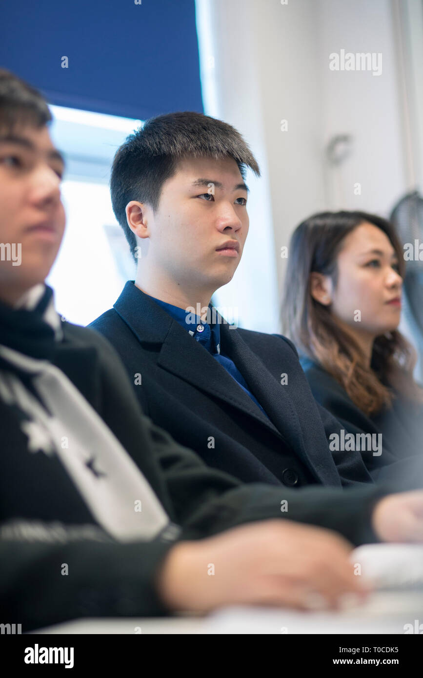 pupils and students in a classroom at a college / university, being ...