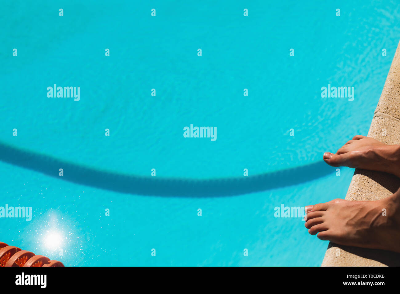 Barefoot of male swimmer standing at swimming pool Stock Photo - Alamy