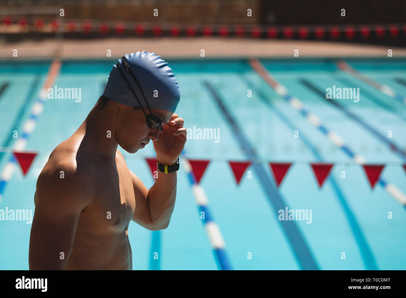 Male swimmer standing at swimming pool Stock Photo - Alamy