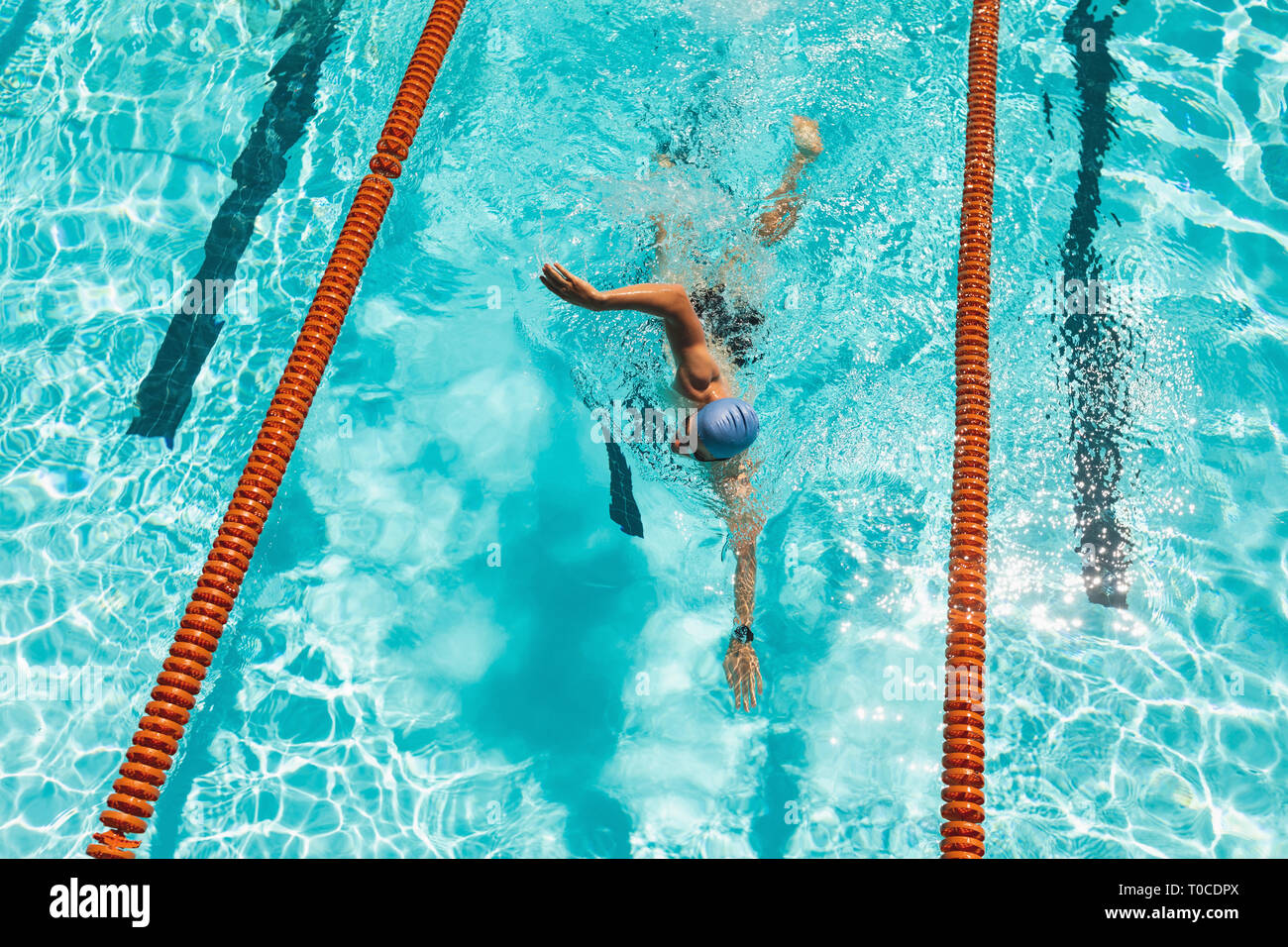 Young Caucasian male swimmer swimming freestyle in swimming pool Stock ...