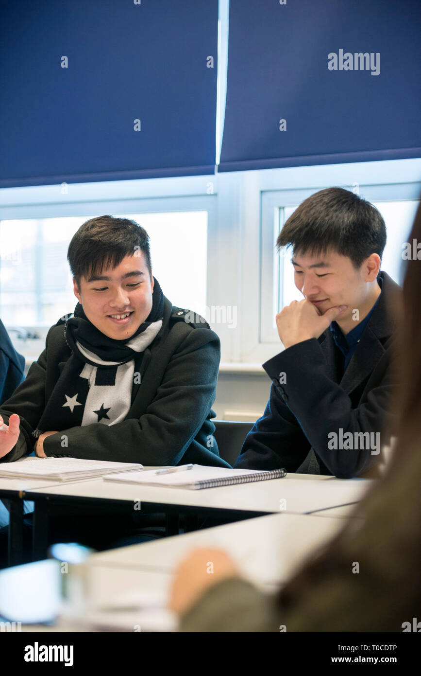 pupils and students in a classroom at a college / university, being ...