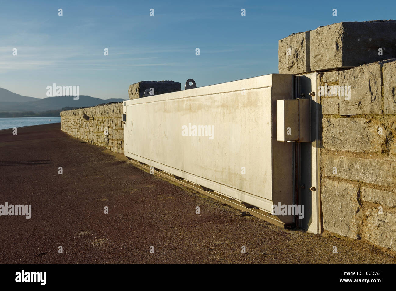 A flood defence barrier gate on the seafront in Beaumaris town centre ...