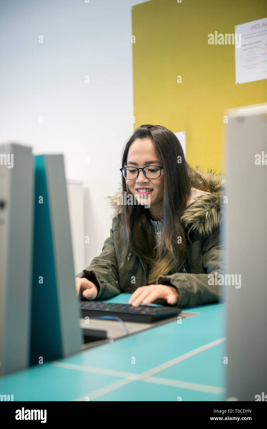 international student and pupil in the computer room of a college ...
