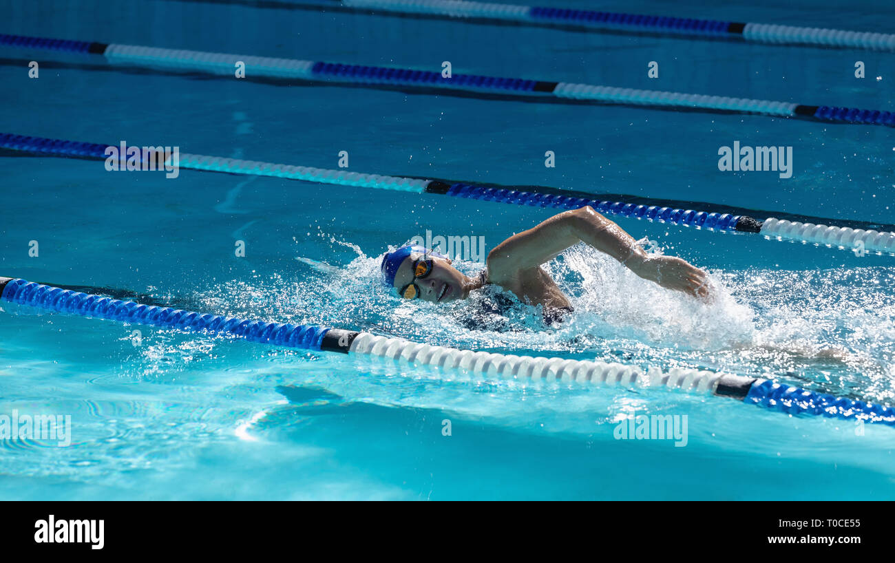 Female swimmer swimming freestyle in swimming pool Stock Photo - Alamy