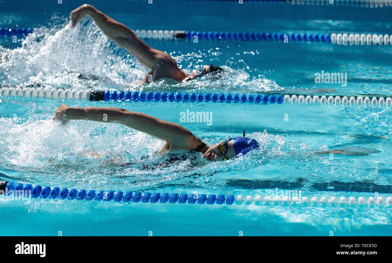 Two female swimmer swimming freestyle in swimming pool Stock Photo - Alamy