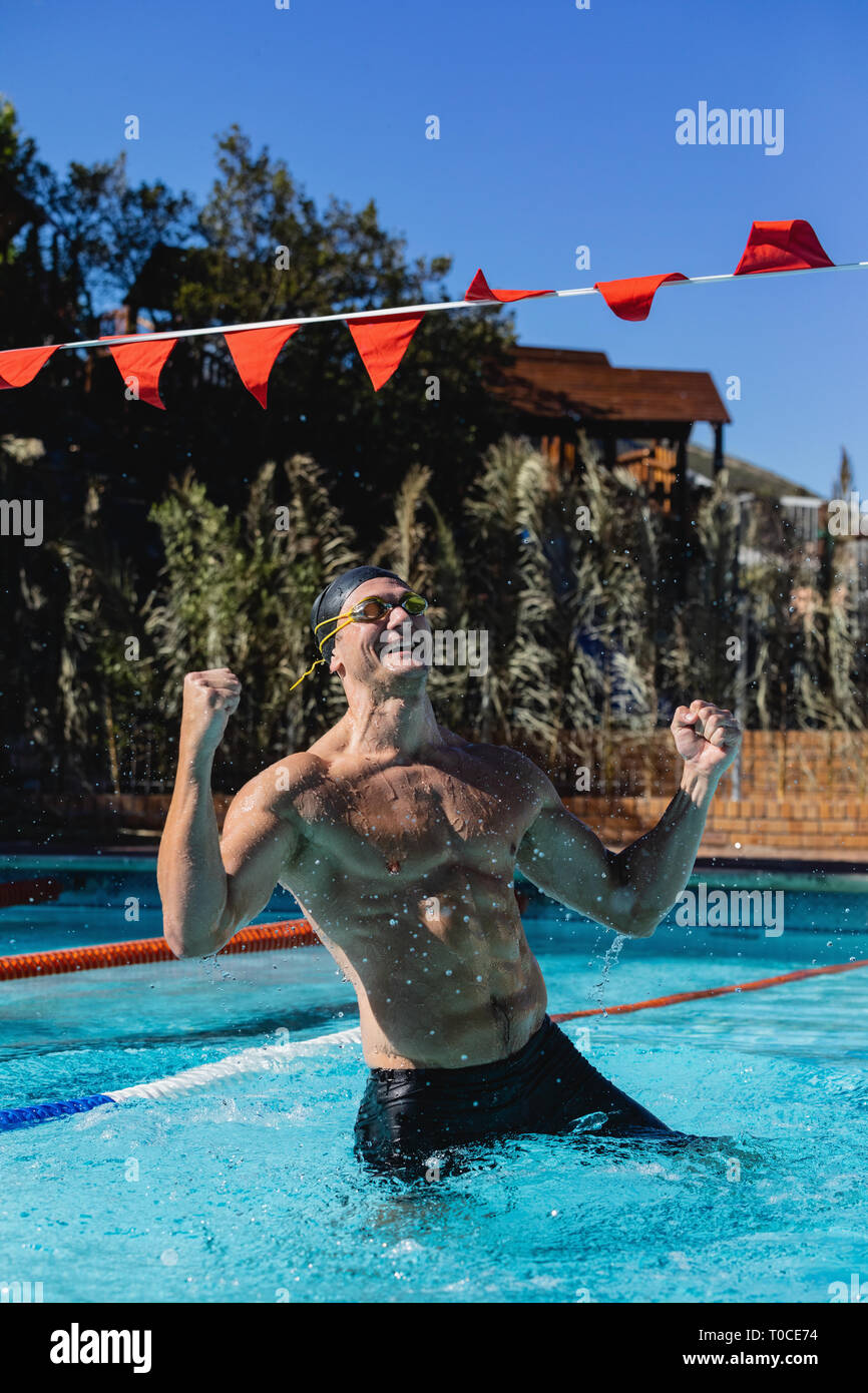 Male swimmer standing in swimming pool Stock Photo - Alamy