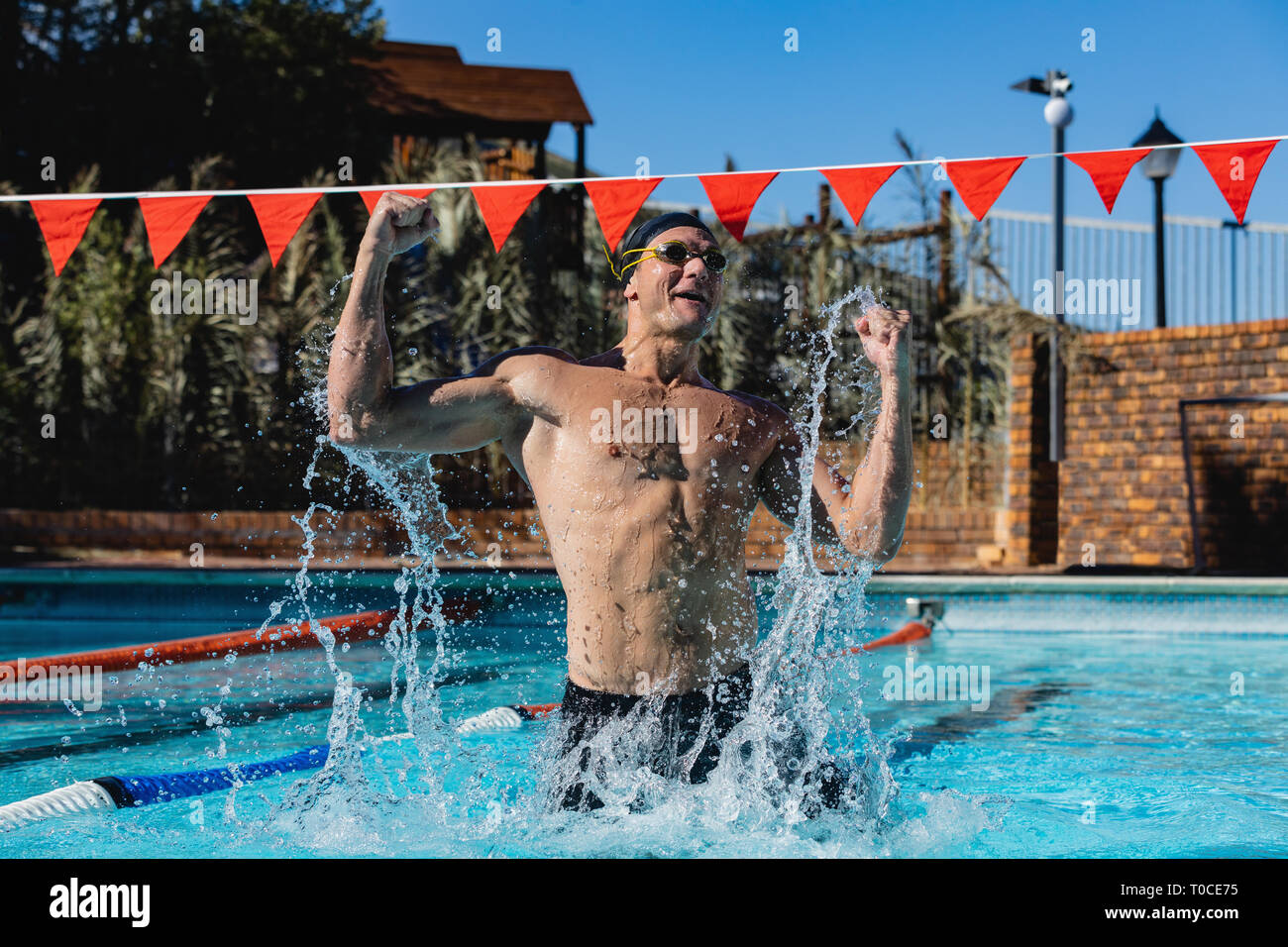 Male swimmer standing in swimming pool Stock Photo - Alamy