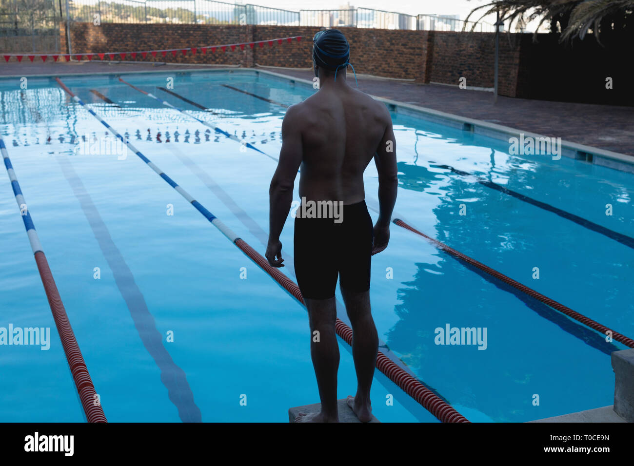 Male swimmer standing in front of the swimming pool Stock Photo - Alamy