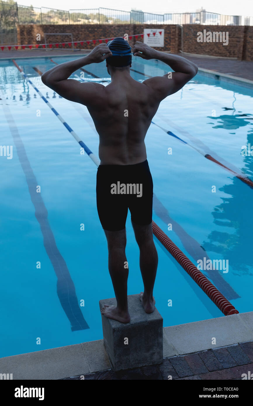 Male swimmer standing in front of the swimming pool Stock Photo - Alamy