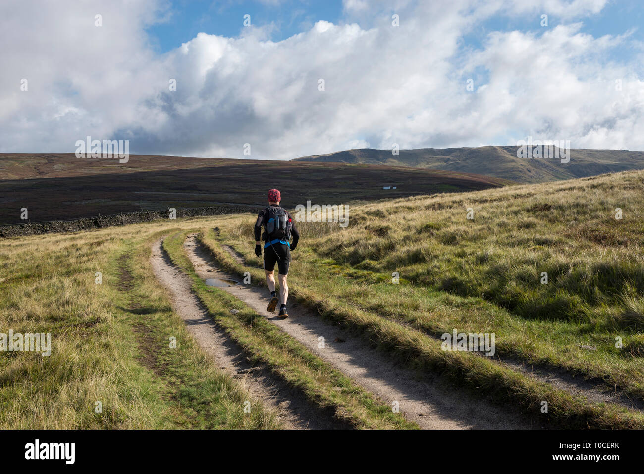 Male runner on the Snake path in the hills above Hayfield, Peak ...