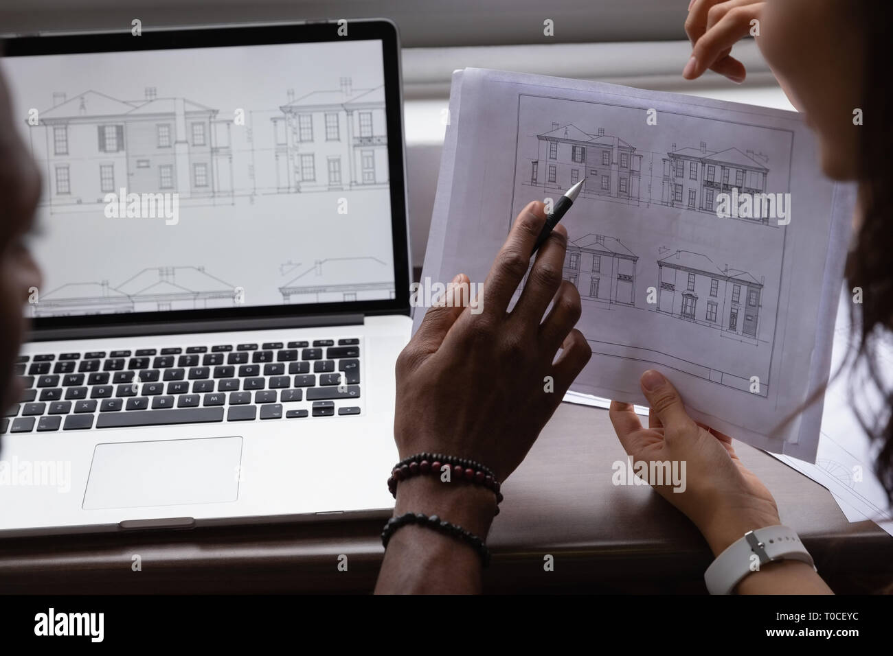 Business people discussing over blueprint in office at desk Stock Photo ...