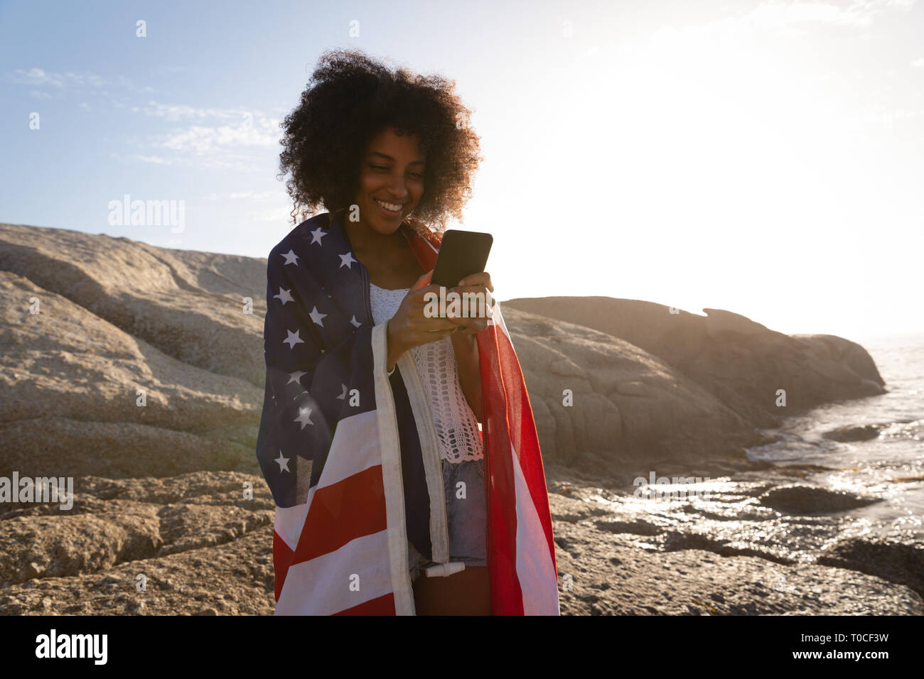 Woman using mobile standing near hi-res stock photography and images - Alamy