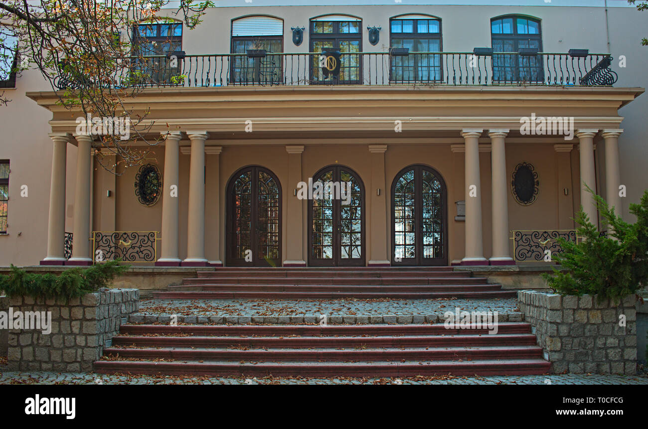 Outside view on entrance into villa with doors, stairs and windows ...