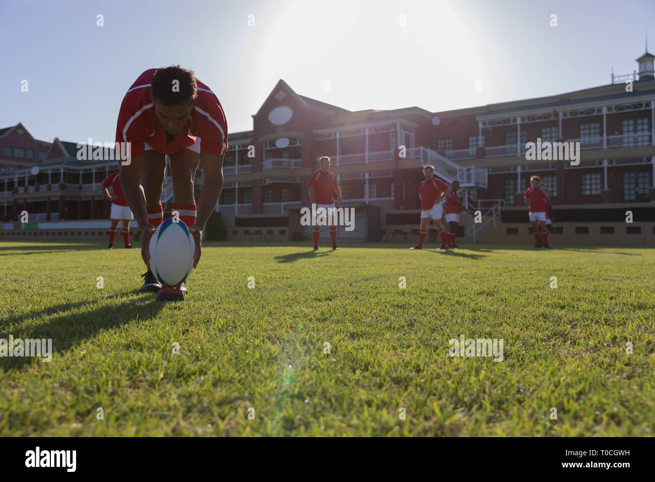 Male rugby player placing rugby ball on a stand in the rugby playground ...