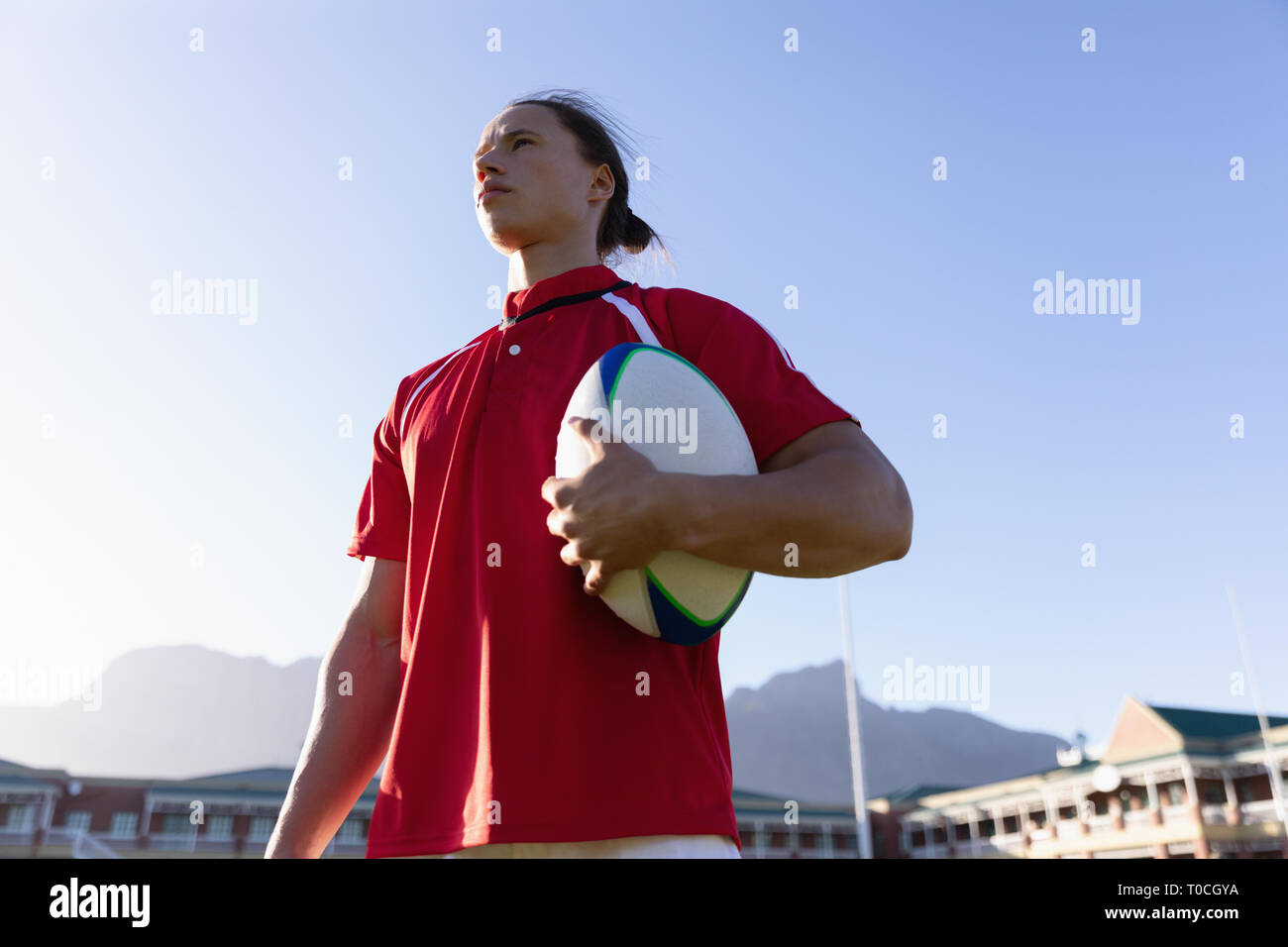Male rugby player holding rugby ball in the ground Stock Photo - Alamy