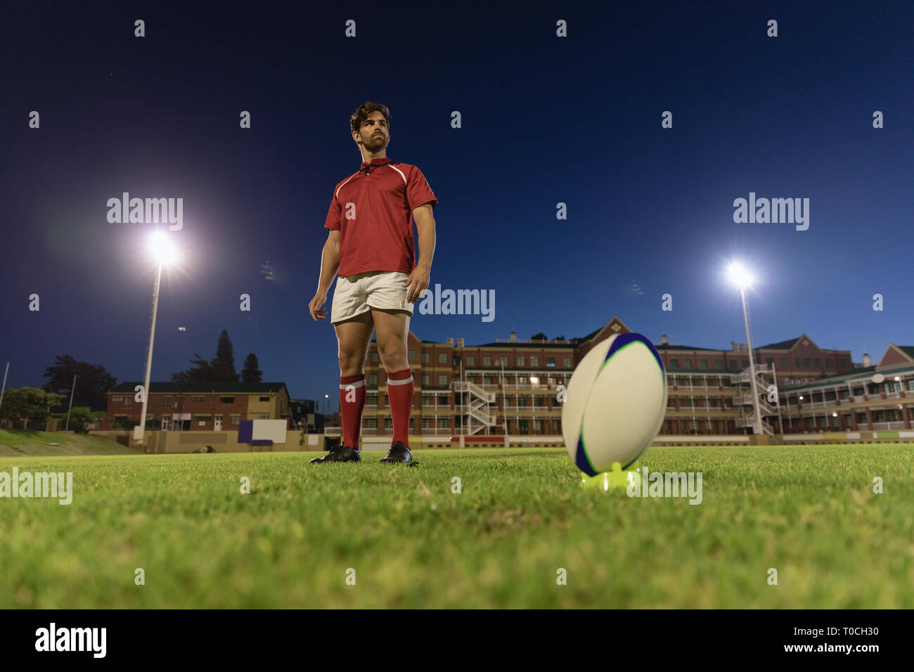 Male rugby player standing with rugby ball in the stadium Stock Photo ...