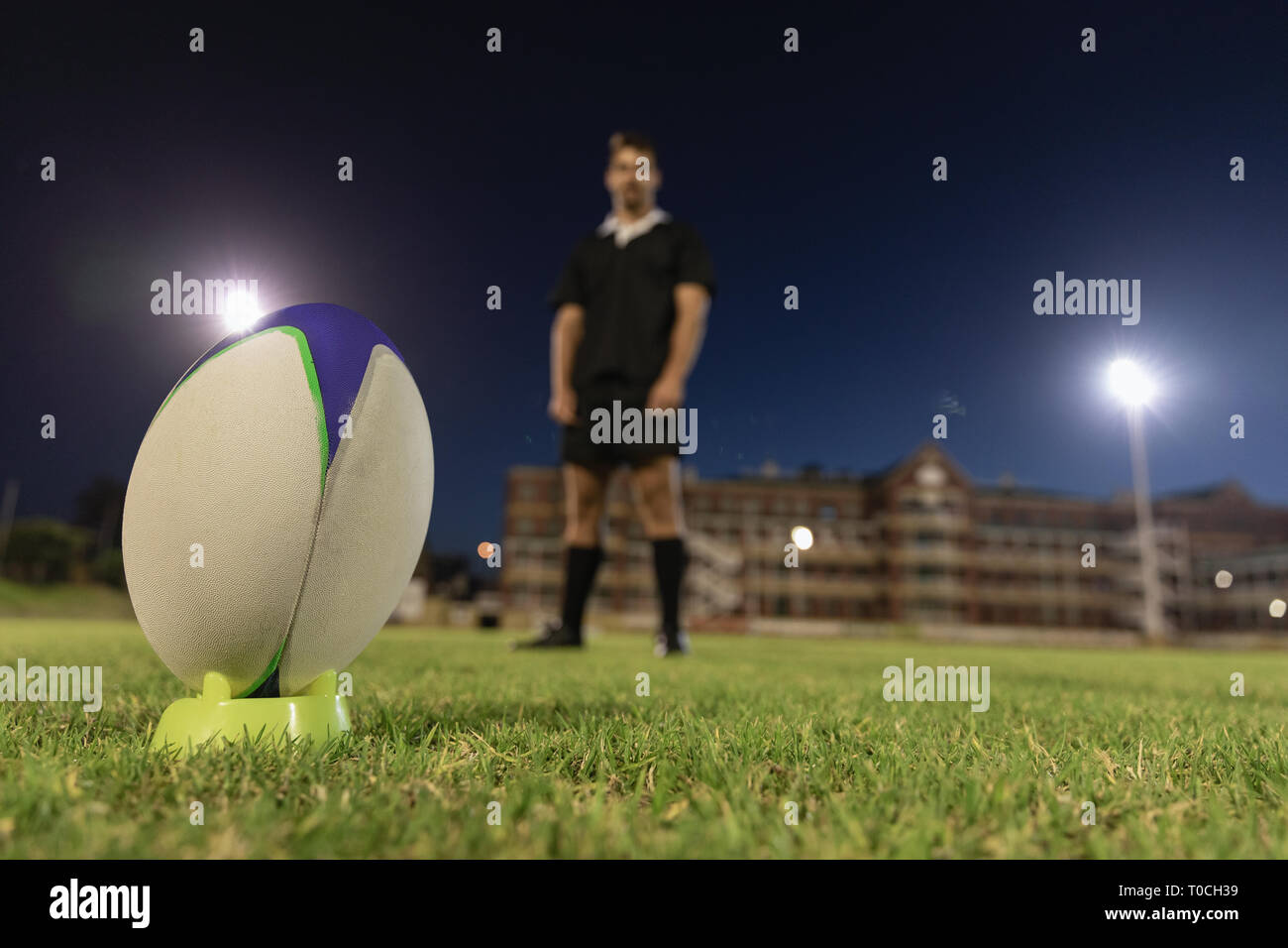 Male rugby player standing with rugby ball in the stadium Stock Photo ...