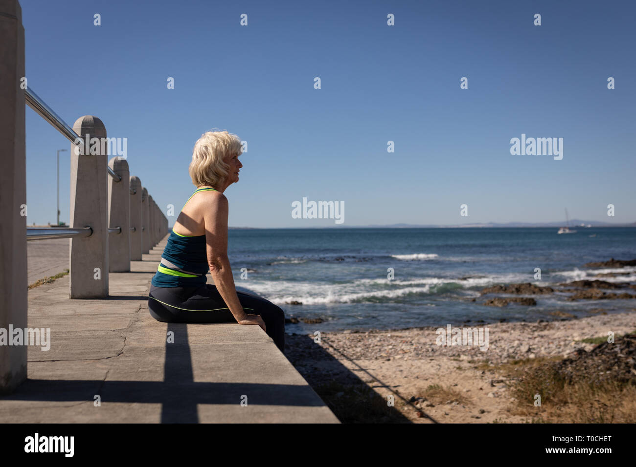 Active senior woman relaxing on a promenade in the sunshine Stock Photo ...