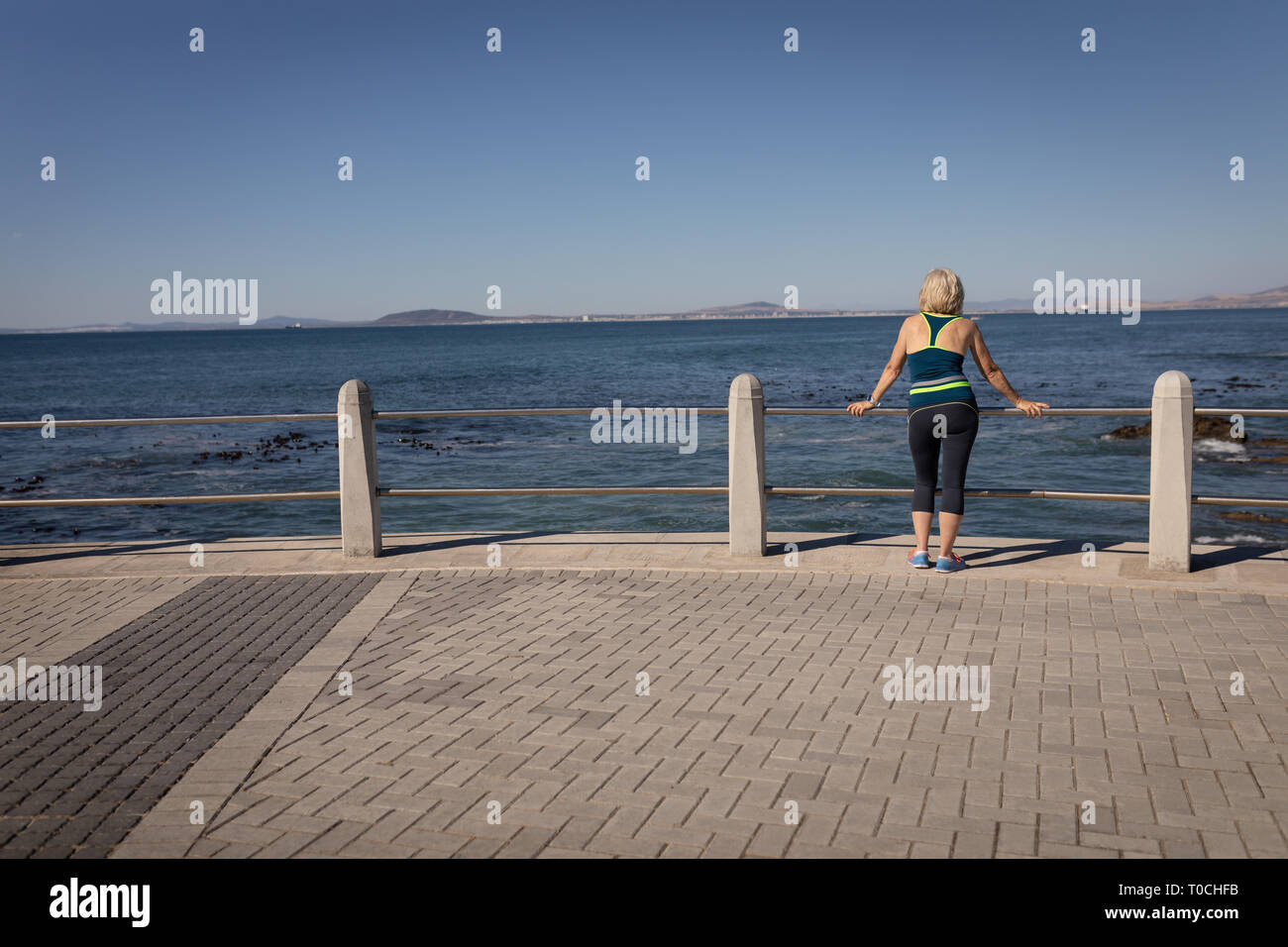 Active senior woman relaxing on a promenade in the sunshine Stock Photo ...