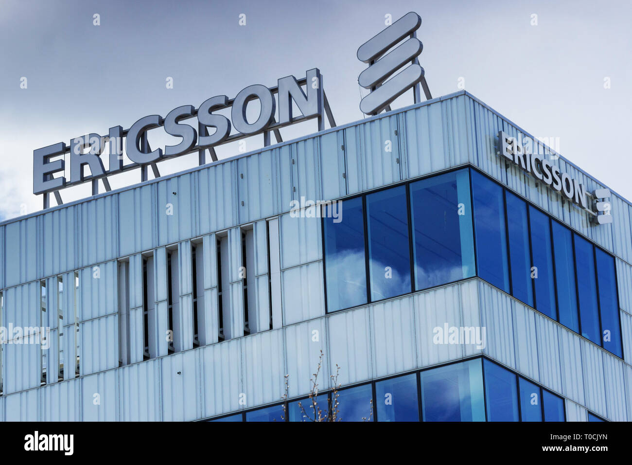 Ericsson white (text) and logo sign on the roof of the company's ...