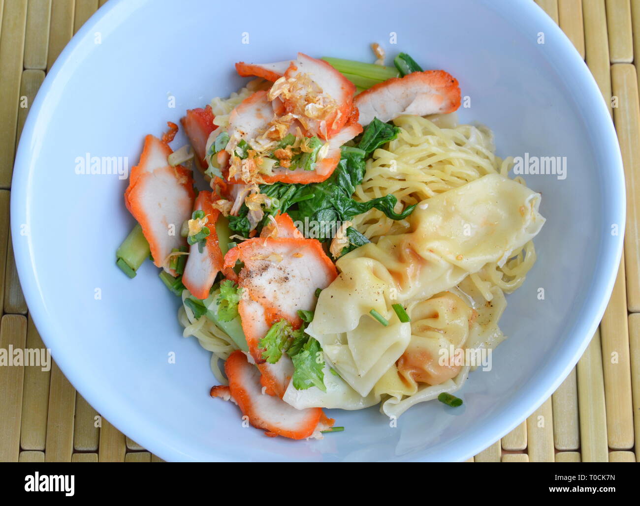 Chinese egg noodle with barbecue pork and dumpling on bowl Stock Photo ...