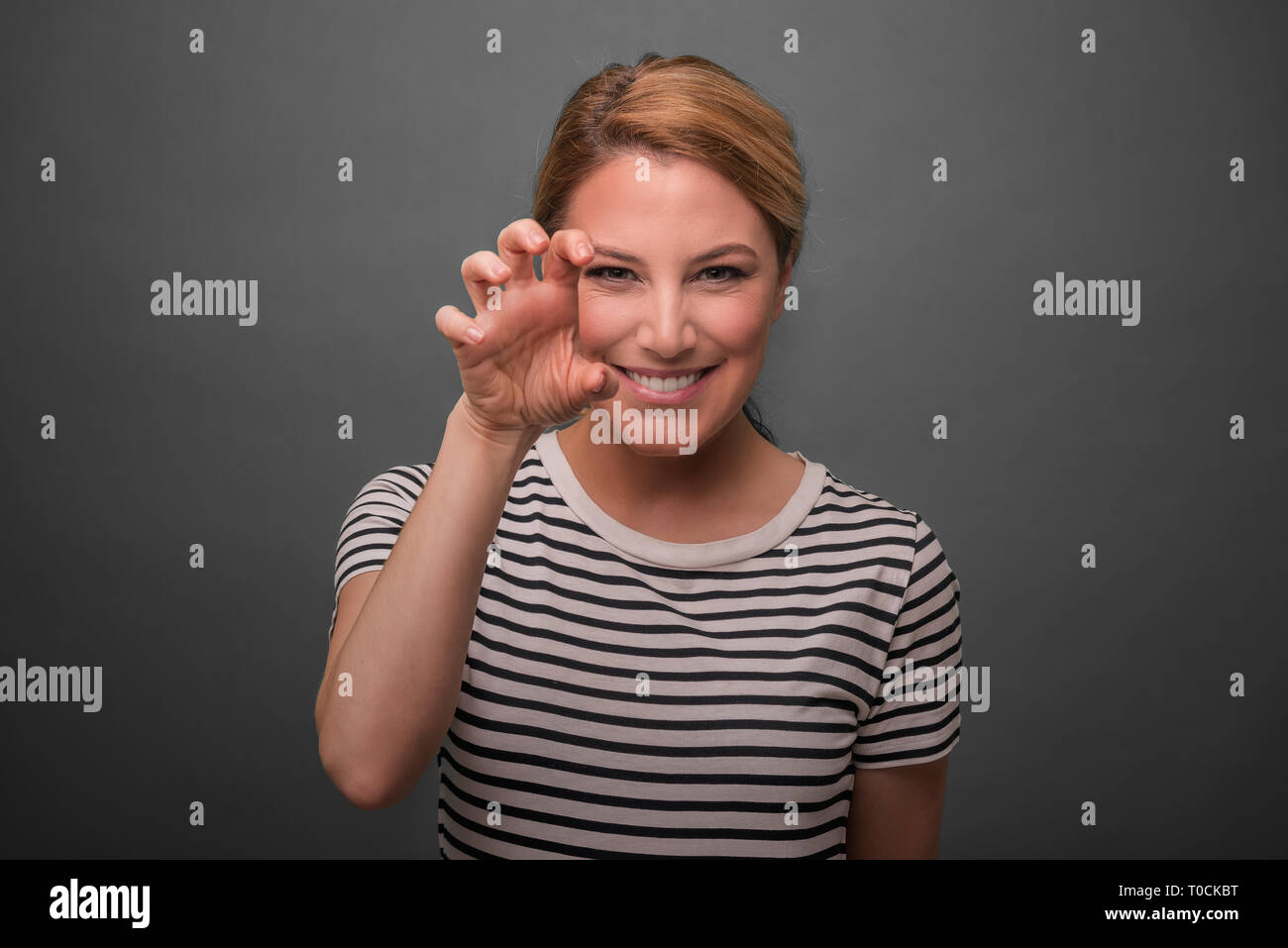 Beautiful young woman showing claws Stock Photo - Alamy