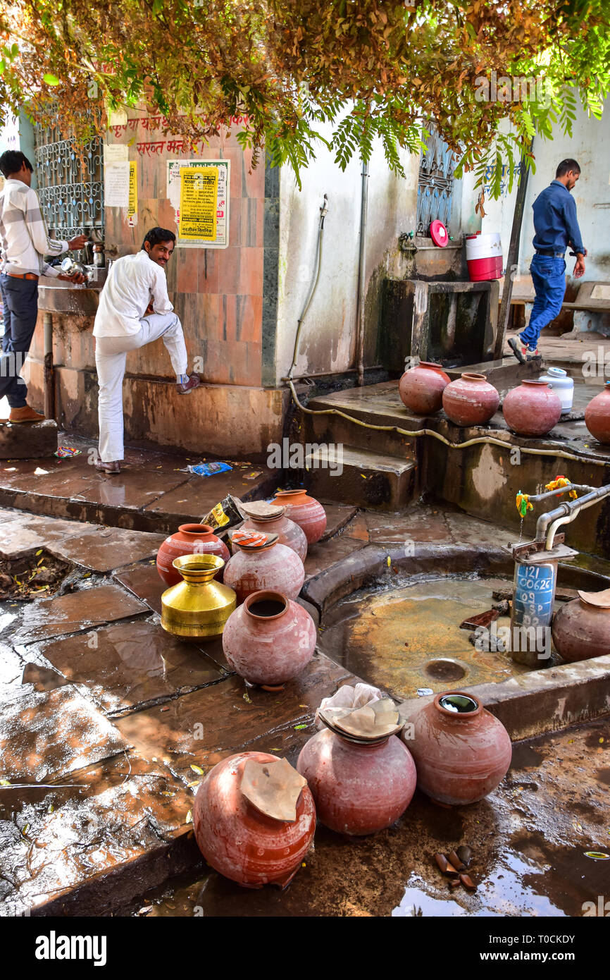 Filling water pots from the well, Bundi, Rajasthan, India Stock Photo ...