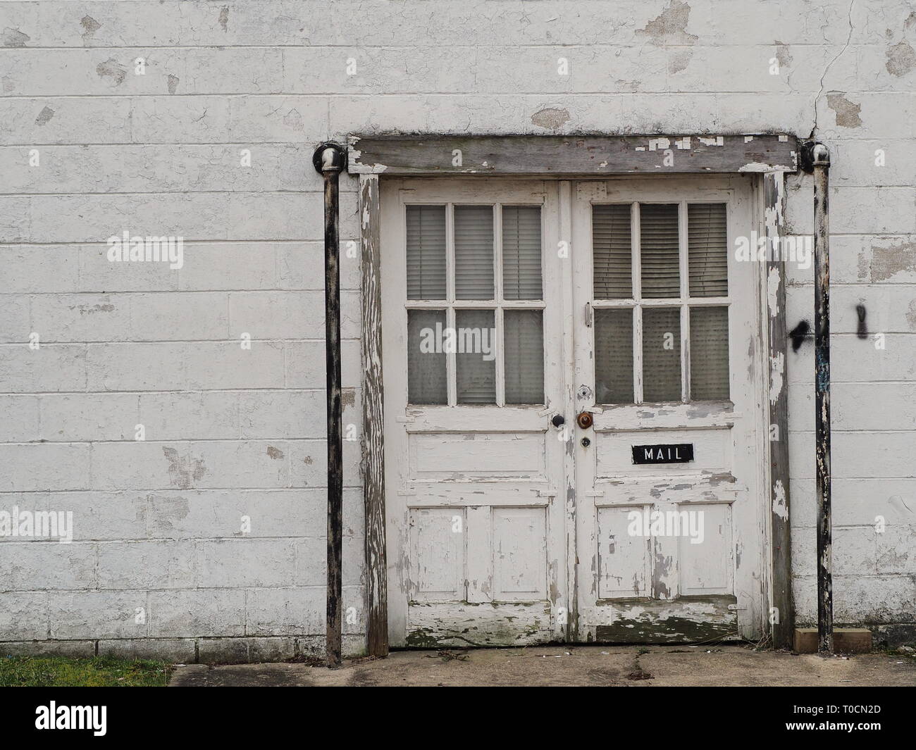 White wall with door way and mail sign Stock Photo - Alamy
