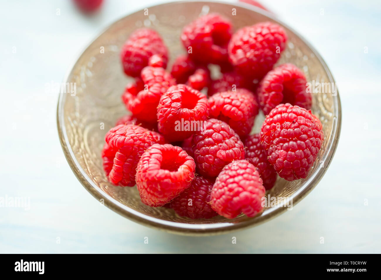Fresh raspberries in bowl Stock Photo - Alamy
