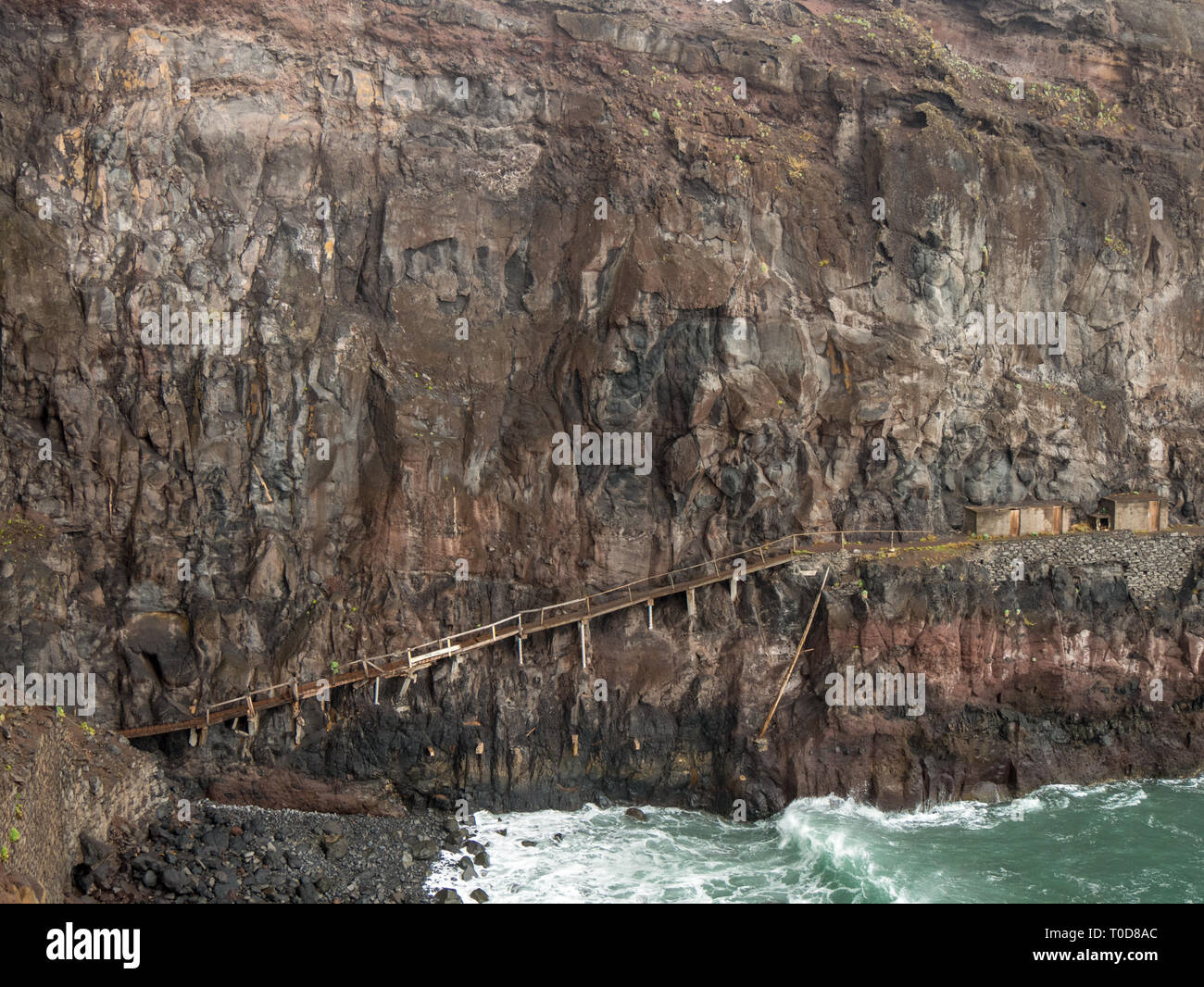 Thrilling wooden bridge on a cliff at the coast near Ponta de Sao Jorge ...