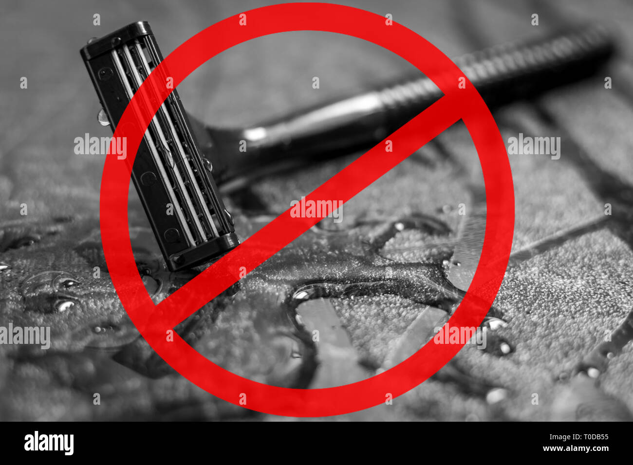 Man's shaving machine kept on a textured wet floor in black and white ...