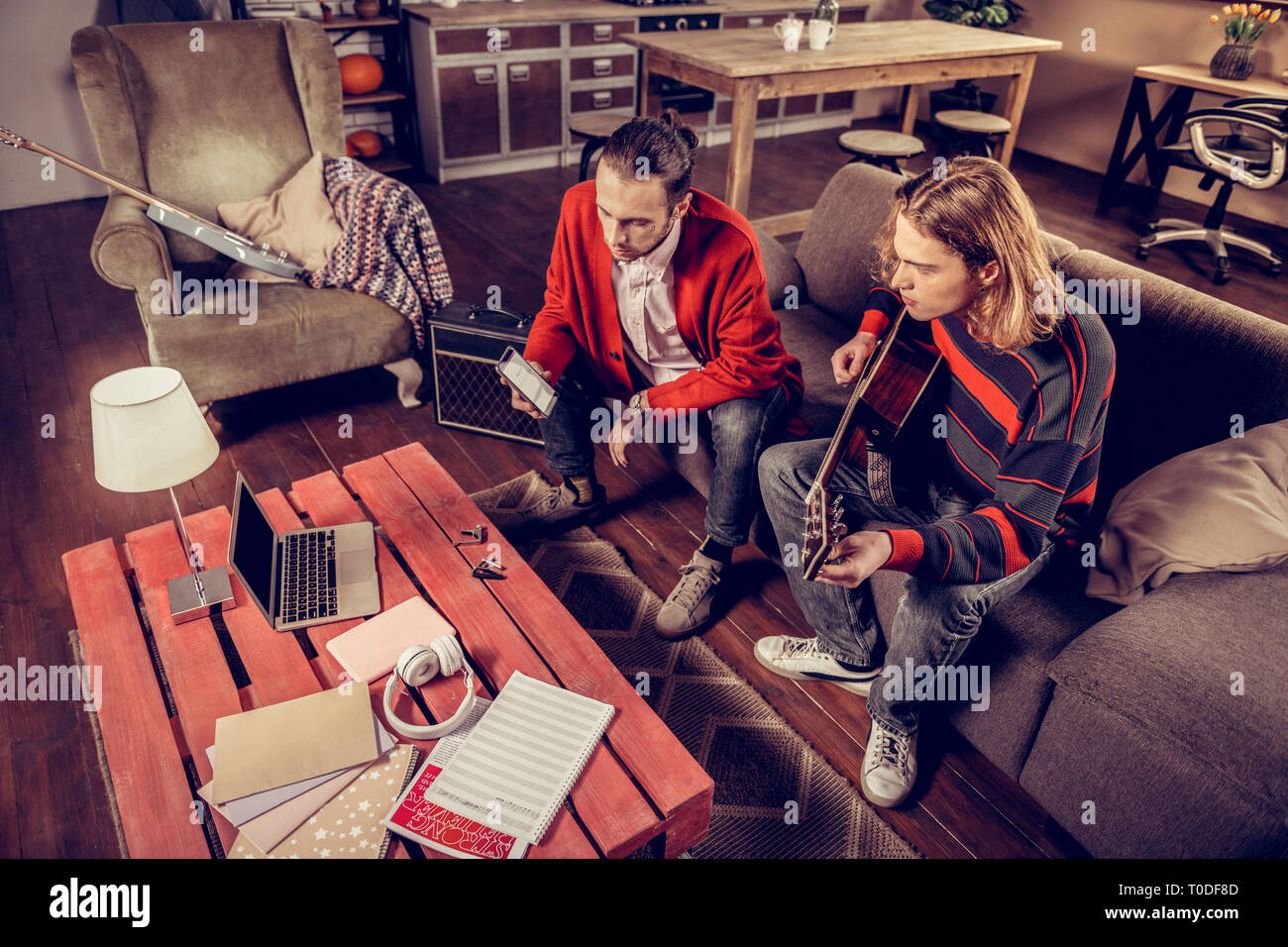 Modern talented musicians using gadgets while composing new song Stock ...