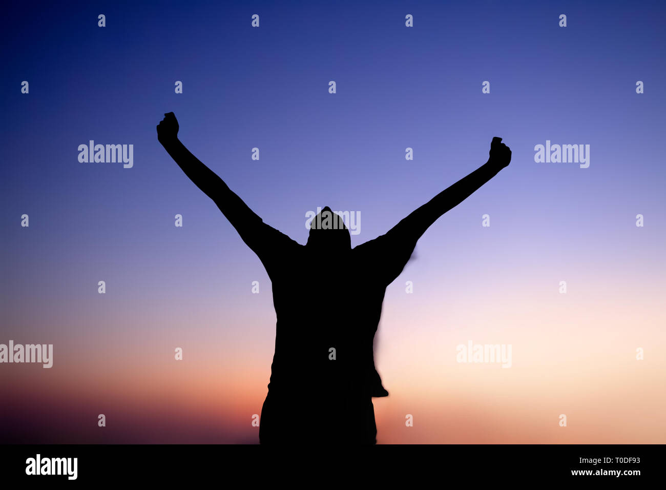 Silhouette of a man with arms raised at night Stock Photo - Alamy