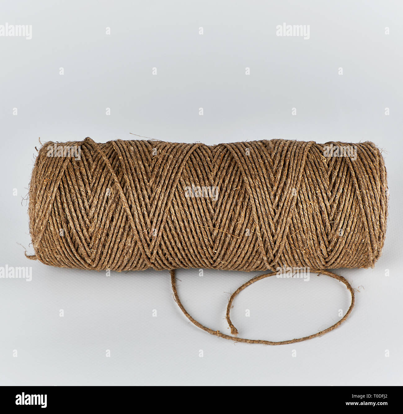 brown rope of jute, white background Stock Photo - Alamy