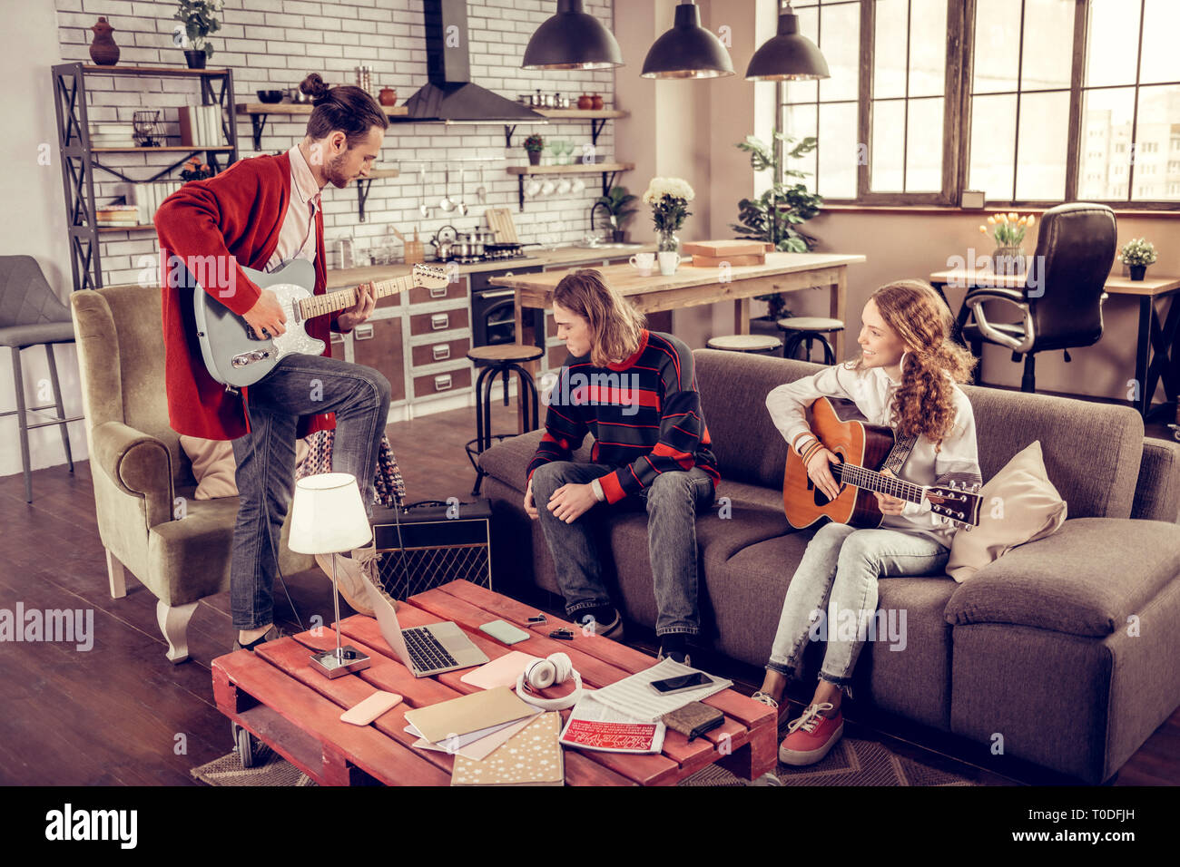 Three talented musicians having little music band having rehearsal ...
