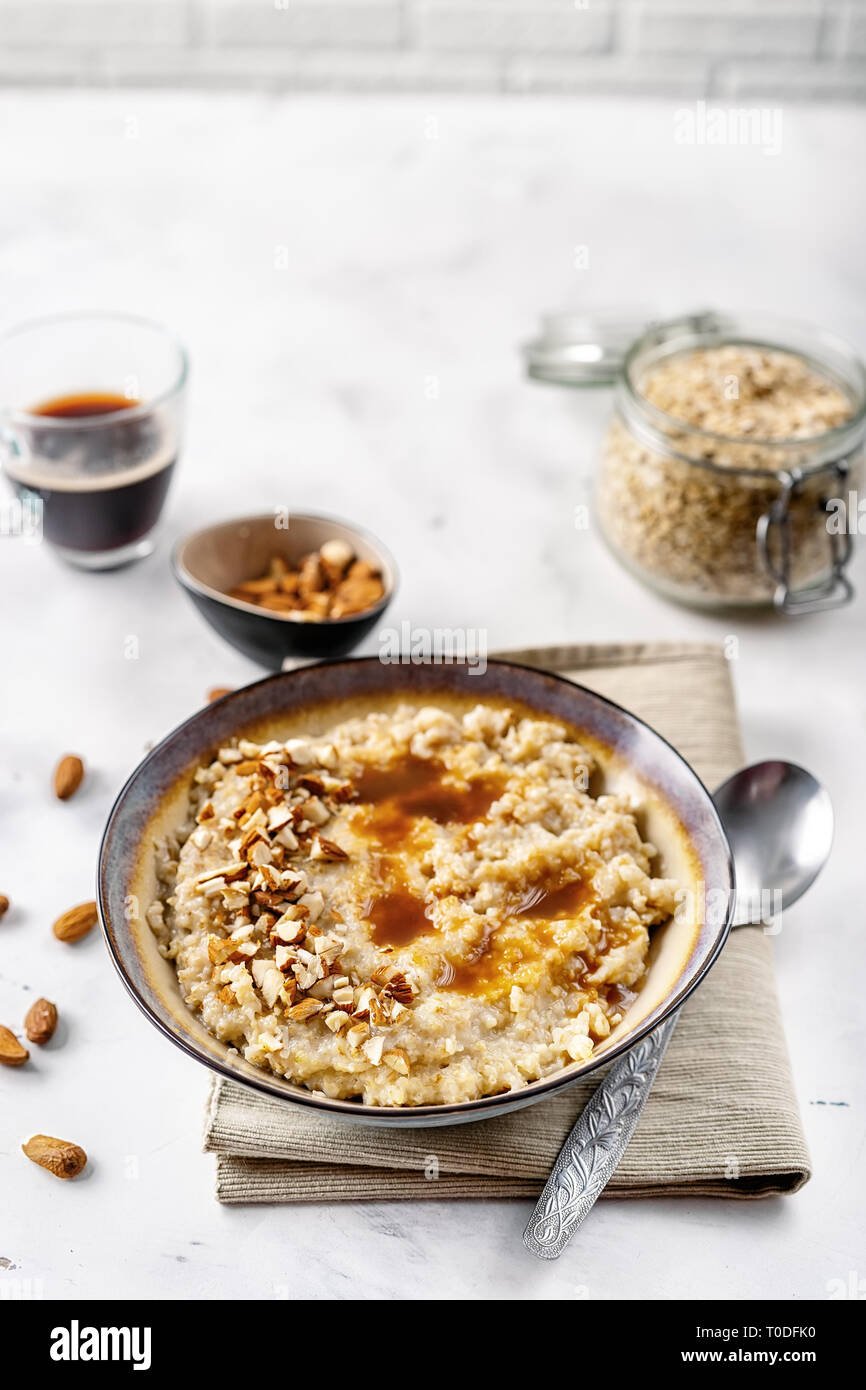 Healthy homemade oatmeal with nuts for breakfast on light background ...