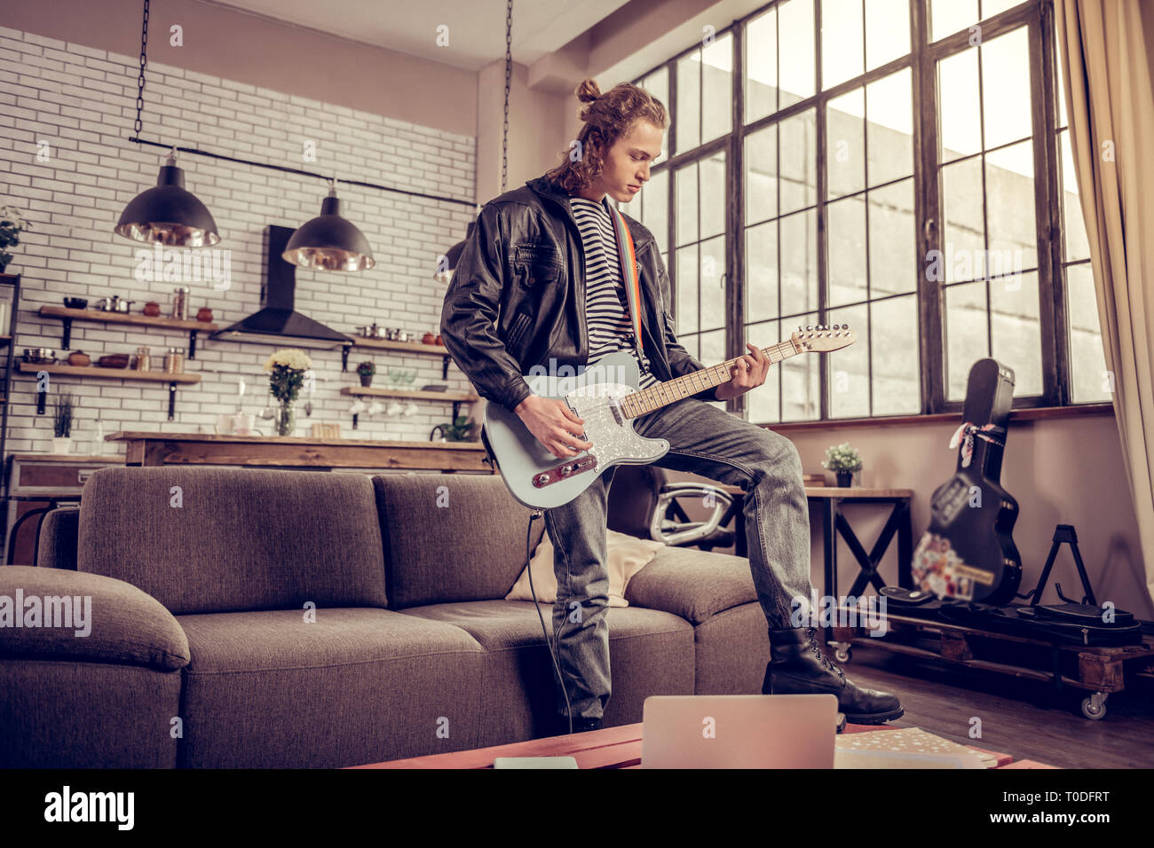 Participant of rock band having rehearsal in the living room Stock ...