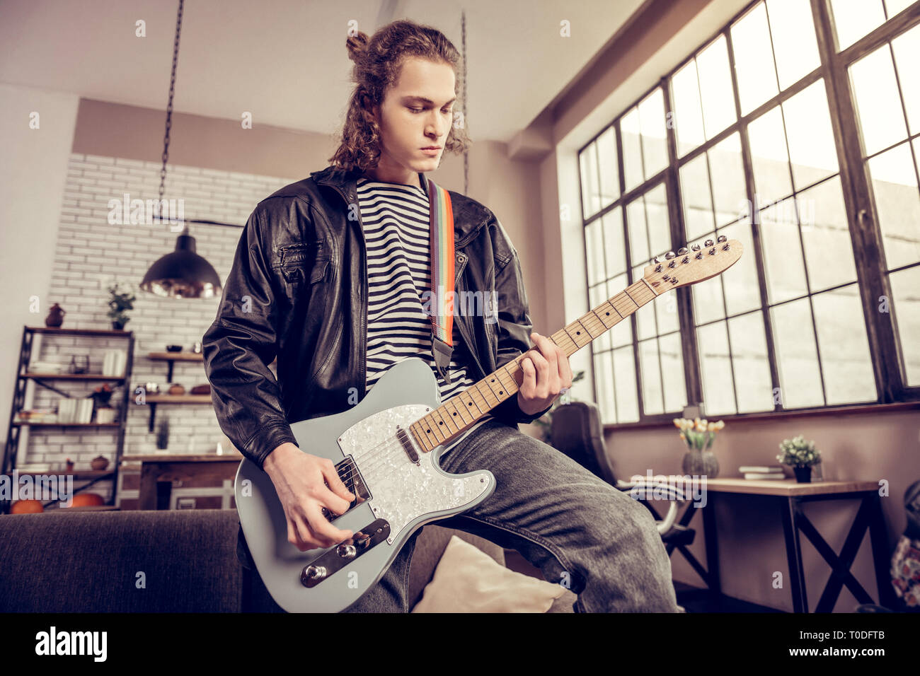 Rock musician wearing leather jacket playing favorite song Stock Photo ...
