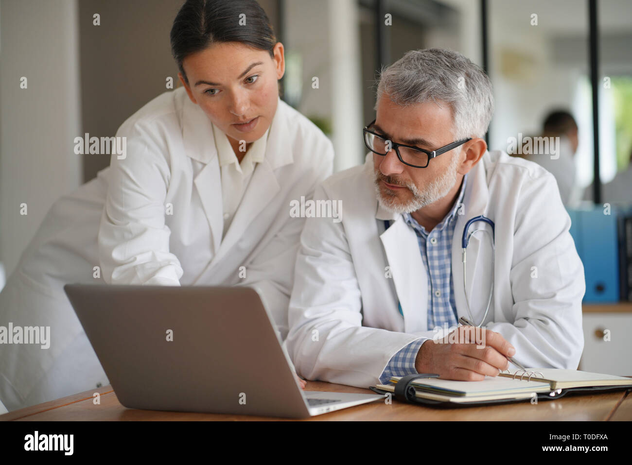 Medical people working together on patient file, hospital office Stock ...