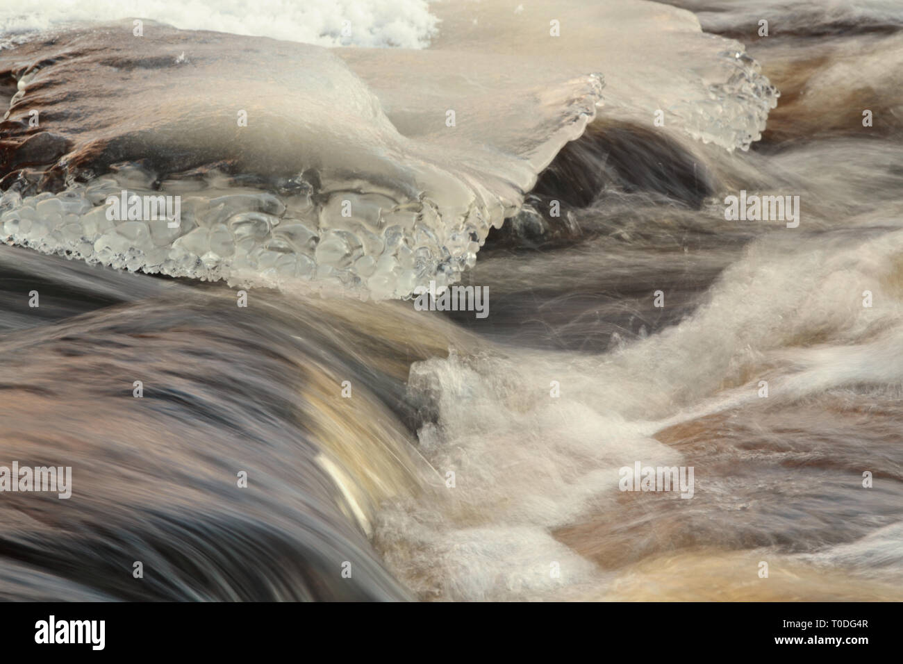 Rapid flowing fast in a finnish river in winter time Stock Photo - Alamy