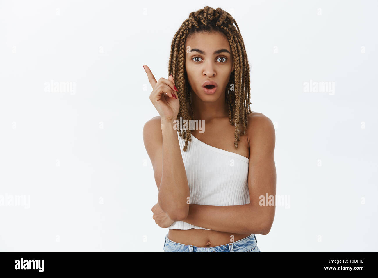 Girl adding suggesting raising index finger in eureka gesture opening ...
