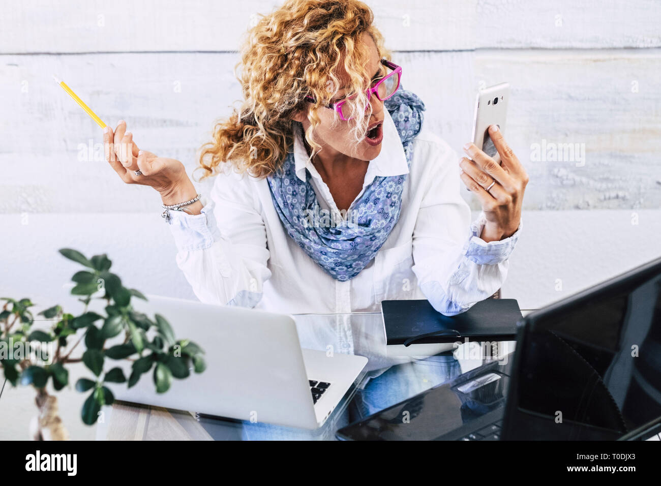 Young business woman manager shout at the phone during work call ...