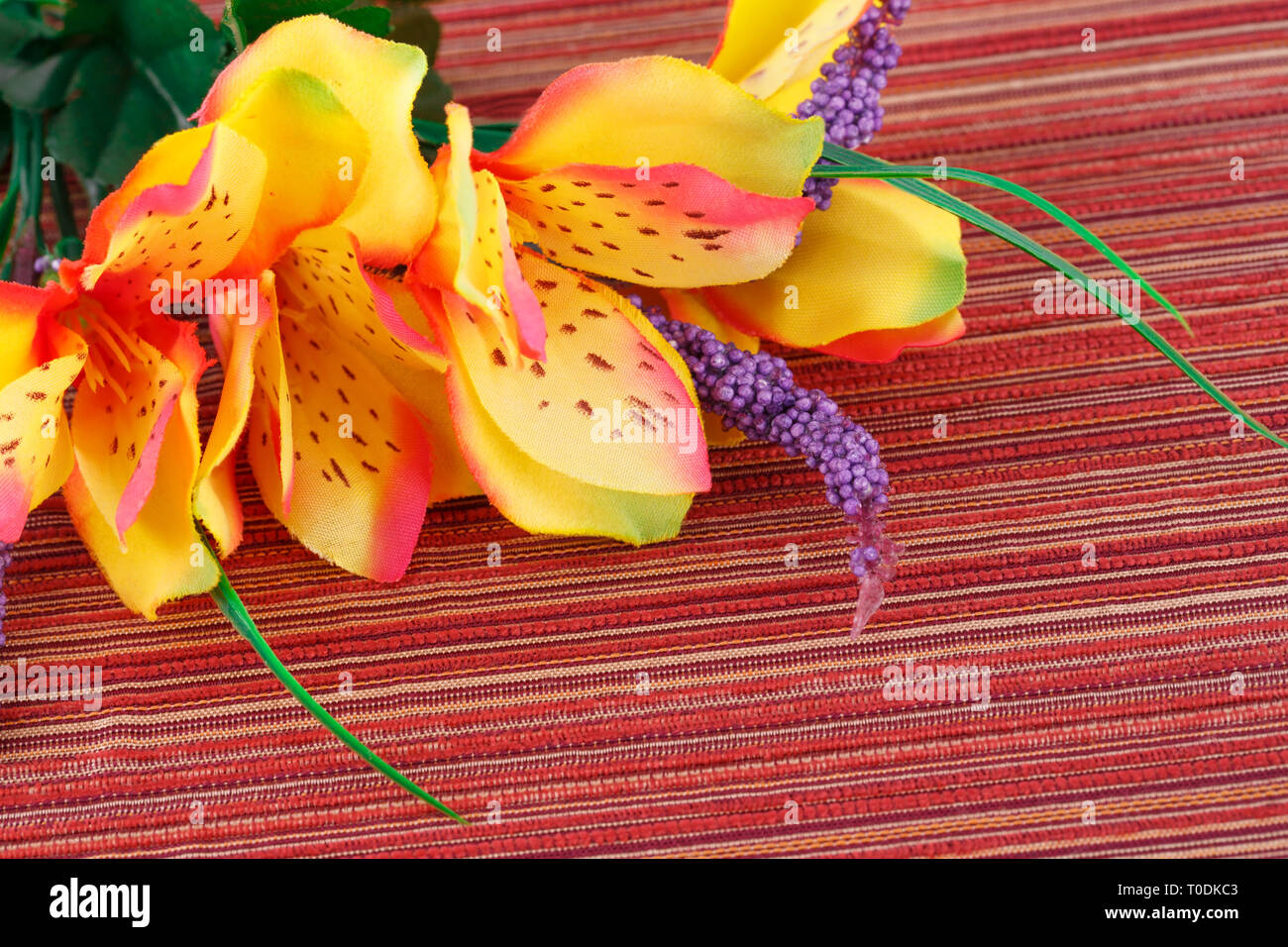 Colorful artificial flowers on cloth background, closeup picture Stock ...