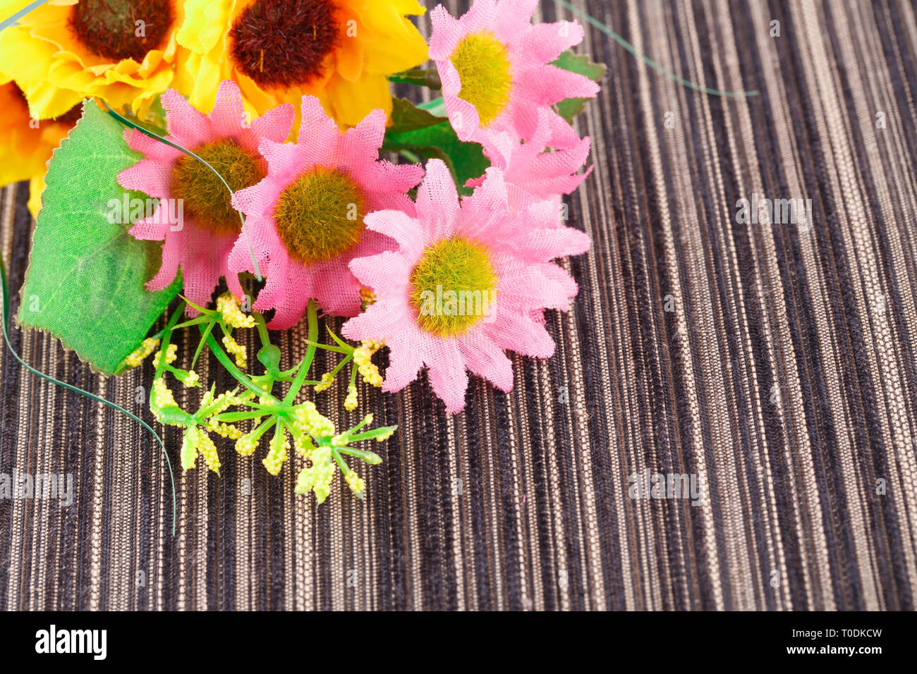 Colorful artificial flowers on cloth background, closeup picture Stock ...