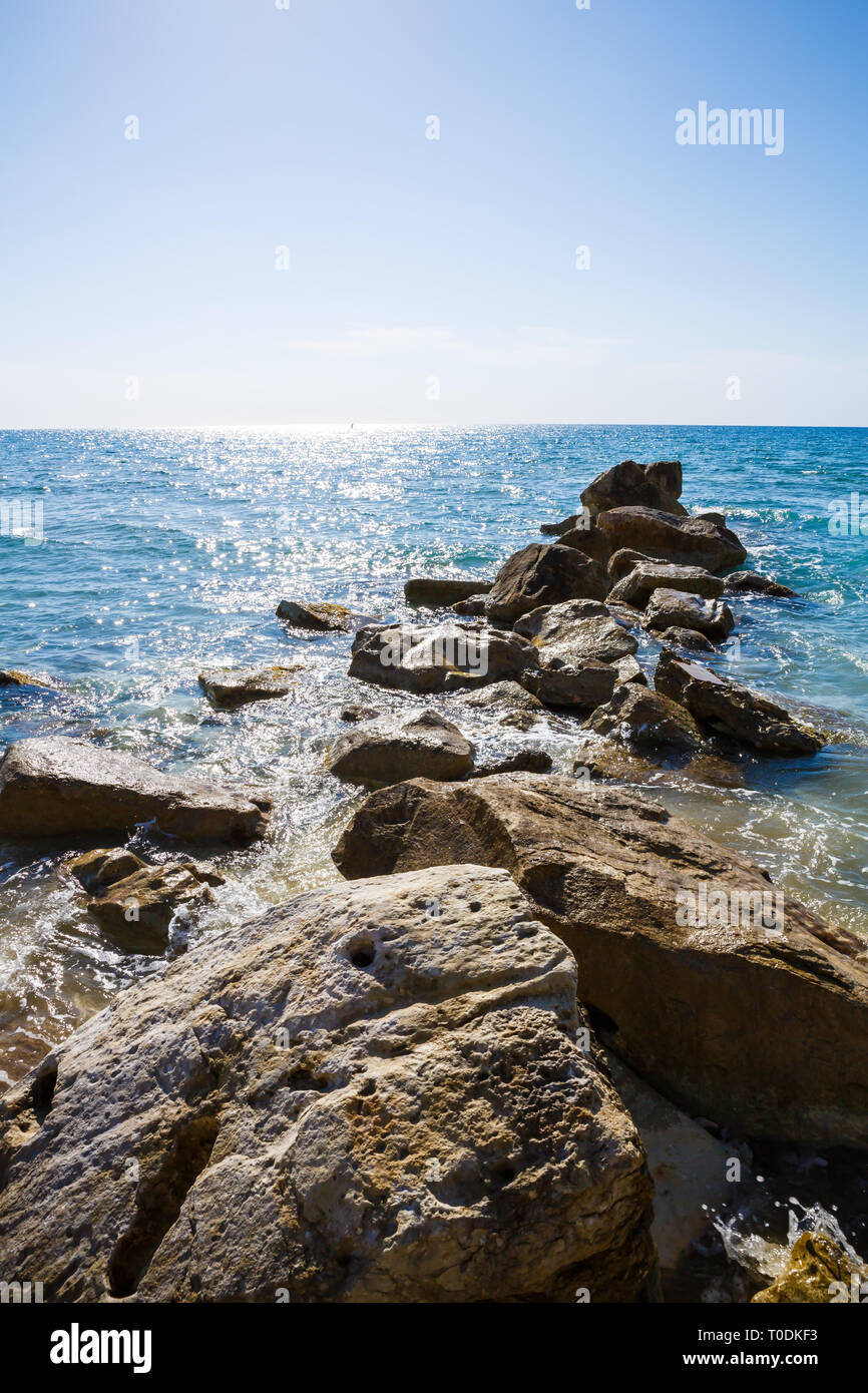 Blue Mediterranean sea with the sparkling surface and stones in Cyprus ...