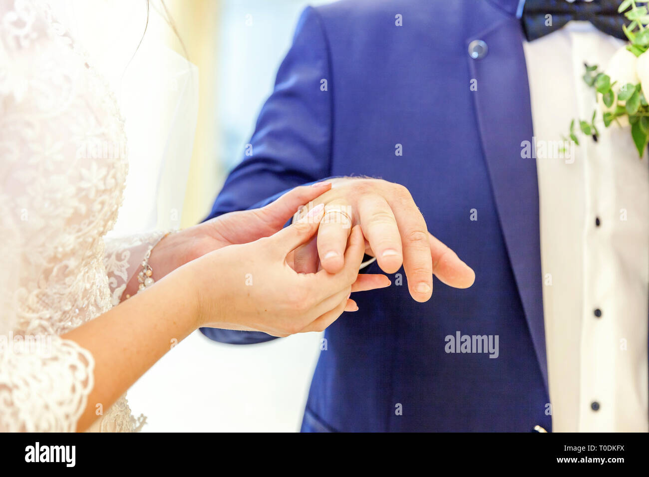 Bride and groom marriage hands with wedding rings. Bride hand putting ...