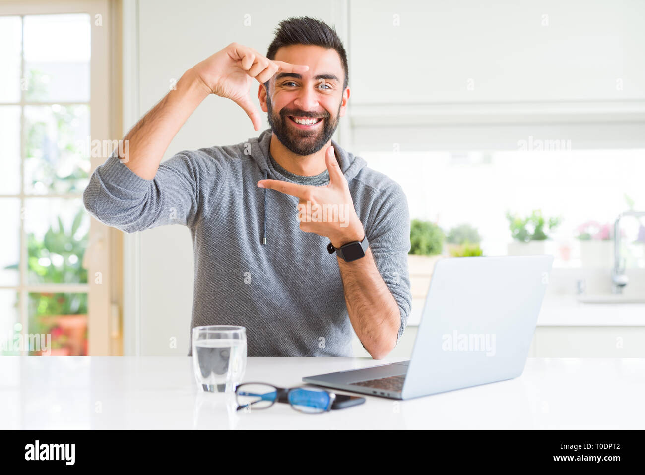 Handsome hispanic man working using computer laptop smiling making ...