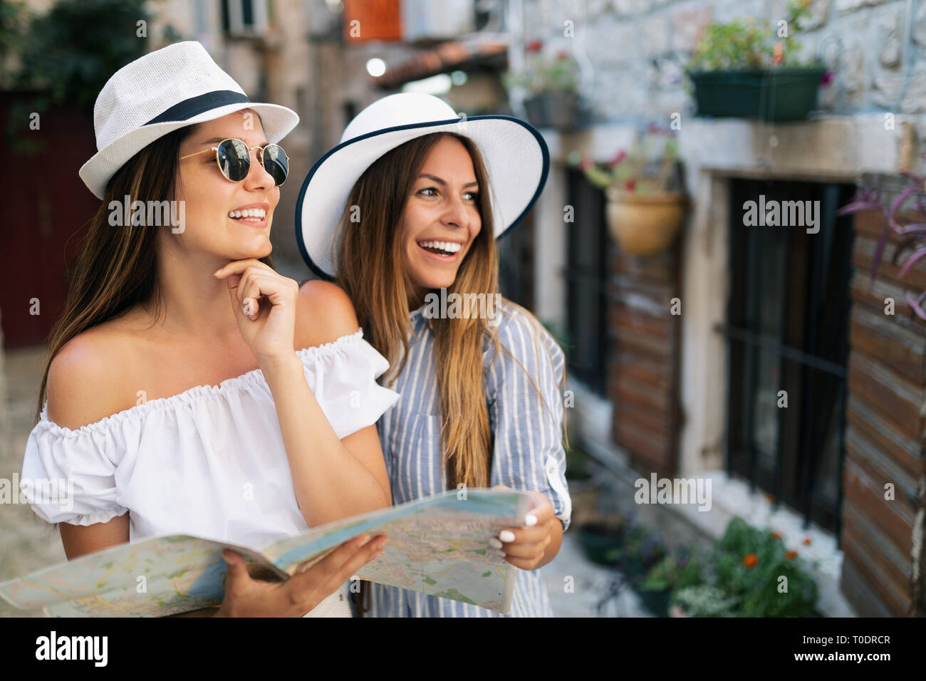 Happy group of friends tourists sightseeing in city on vacation Stock ...