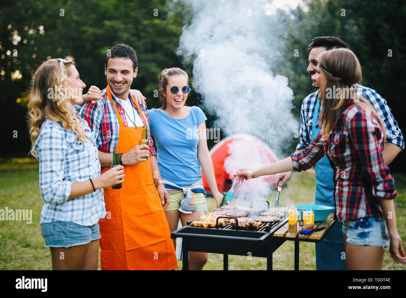 Young people in nature having fun and smiling Stock Photo - Alamy