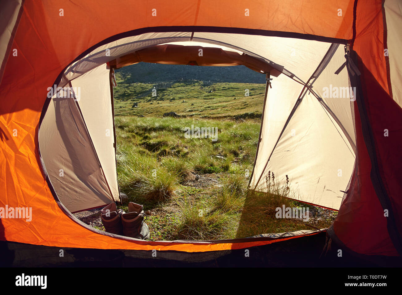 hiking tourist boots standing at the exit of a tent Stock Photo - Alamy